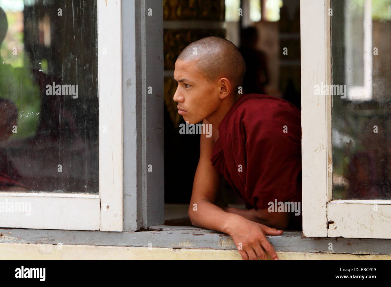 Novices looking out of a window, Burma Stock Photo - Alamy