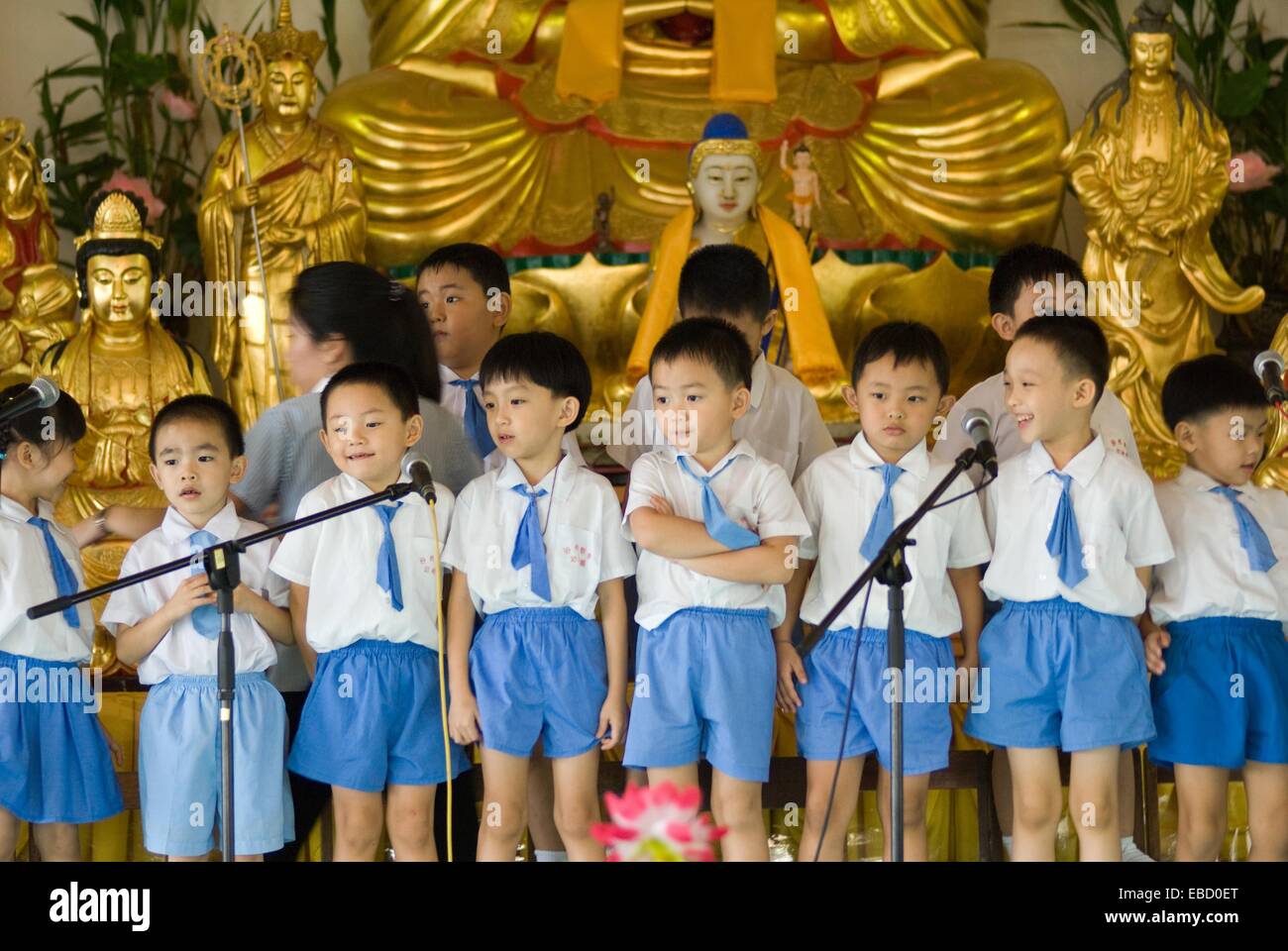 Group of children singing on stage Stock Photo - Alamy