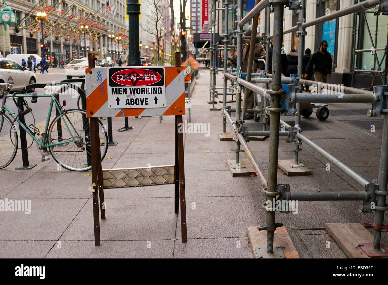 Men working above sign on construction horse. State Street, Chicago ...