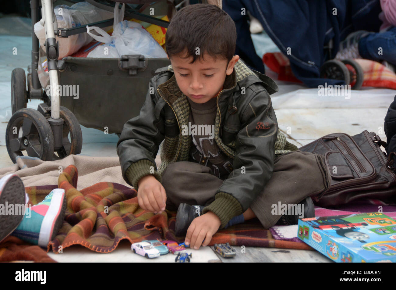 A boy from Syria plays with his toys. Syrian refugees that ive in ...