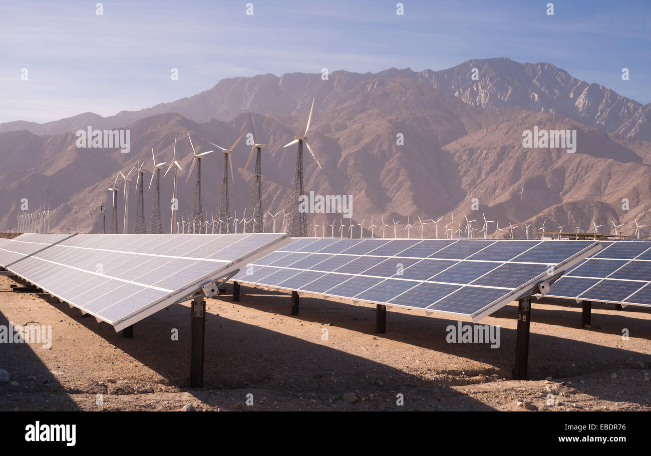 A large solar power farm with wind turbines in the background Stock ...