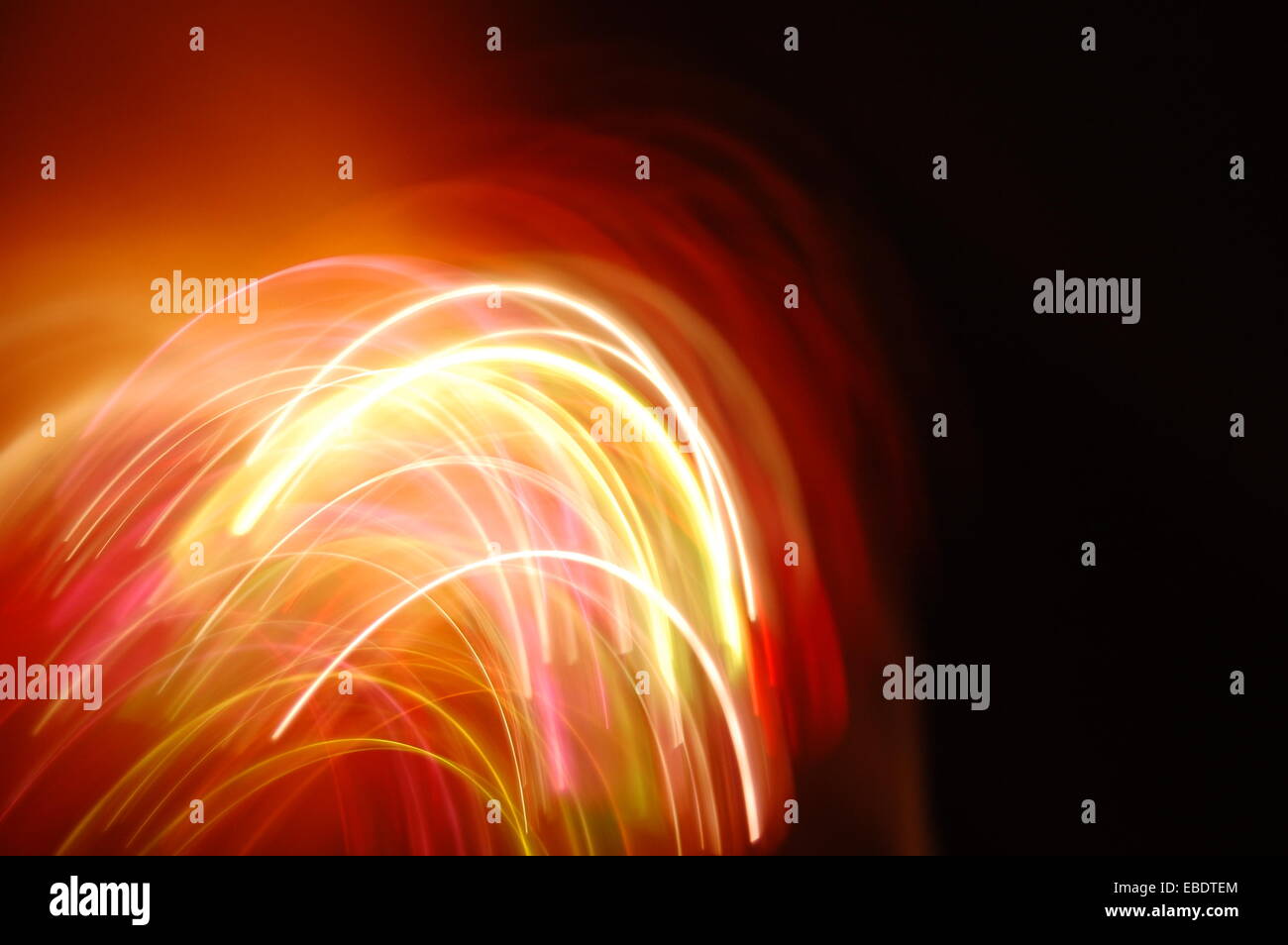 Colourful light beams on a dark background Stock Photo - Alamy