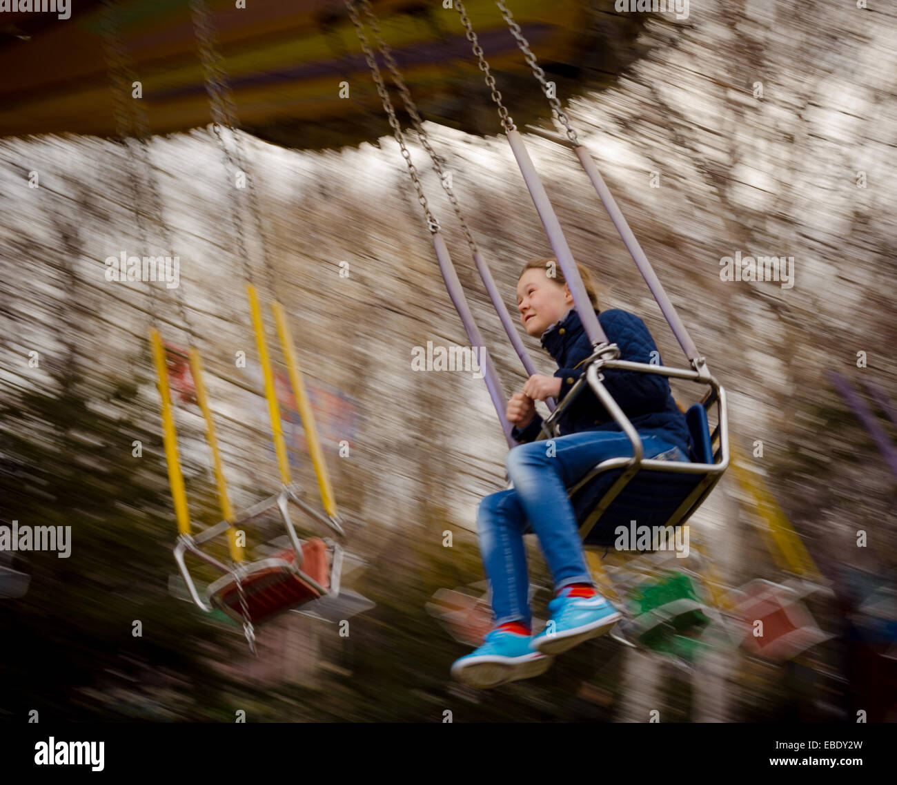 Girl spinning on the merry-go-round at an amusement park Stock Photo ...