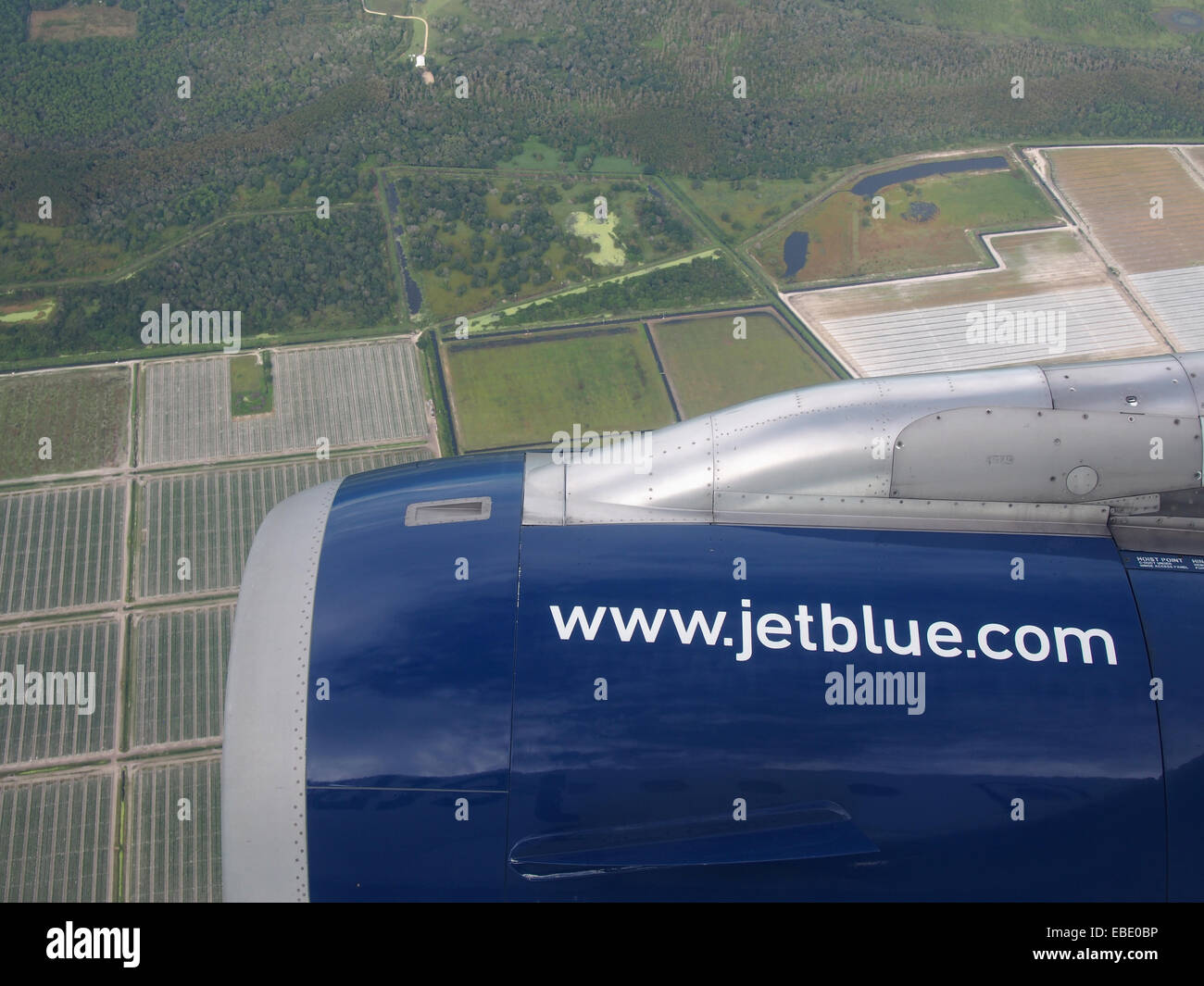 View of Jet Blue engine and scenery during flight over Florida, USA ...