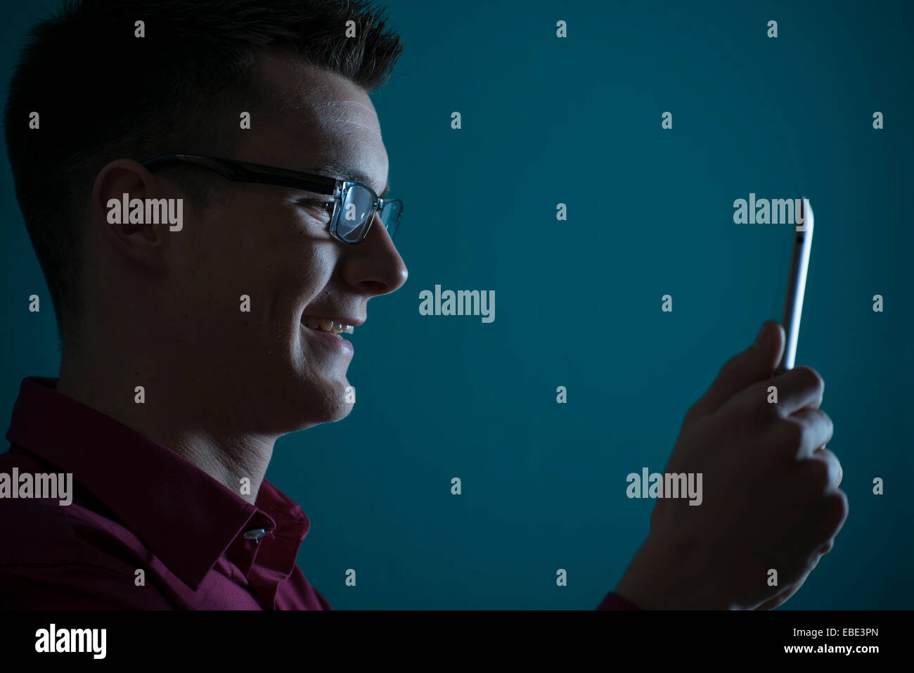 Young Man looking at Tablet Computer, Studio Shot Stock Photo - Alamy