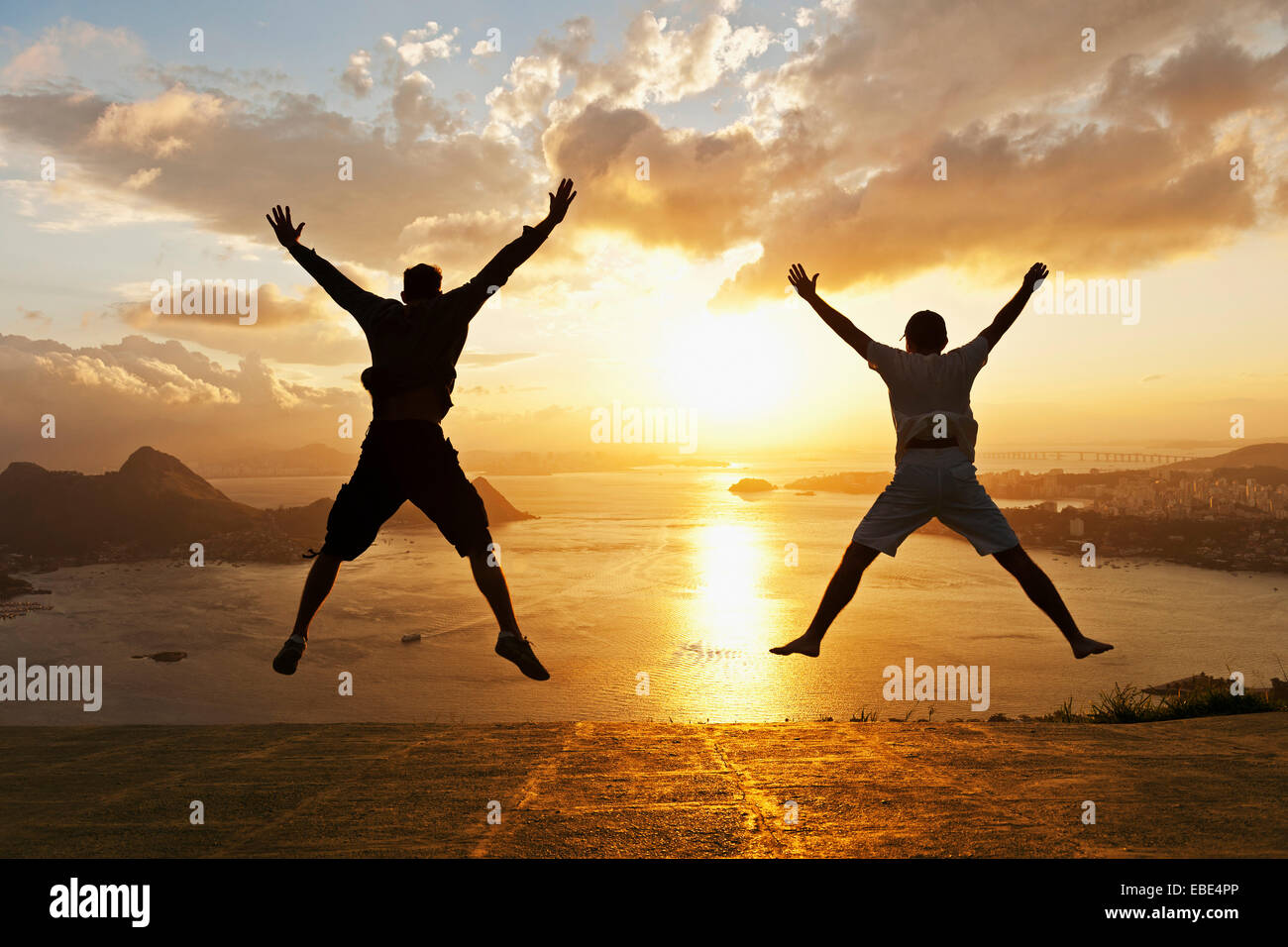 Teenagers doing Star Jumps at Sunset overlooking Rio de Janeiro, Brazil ...