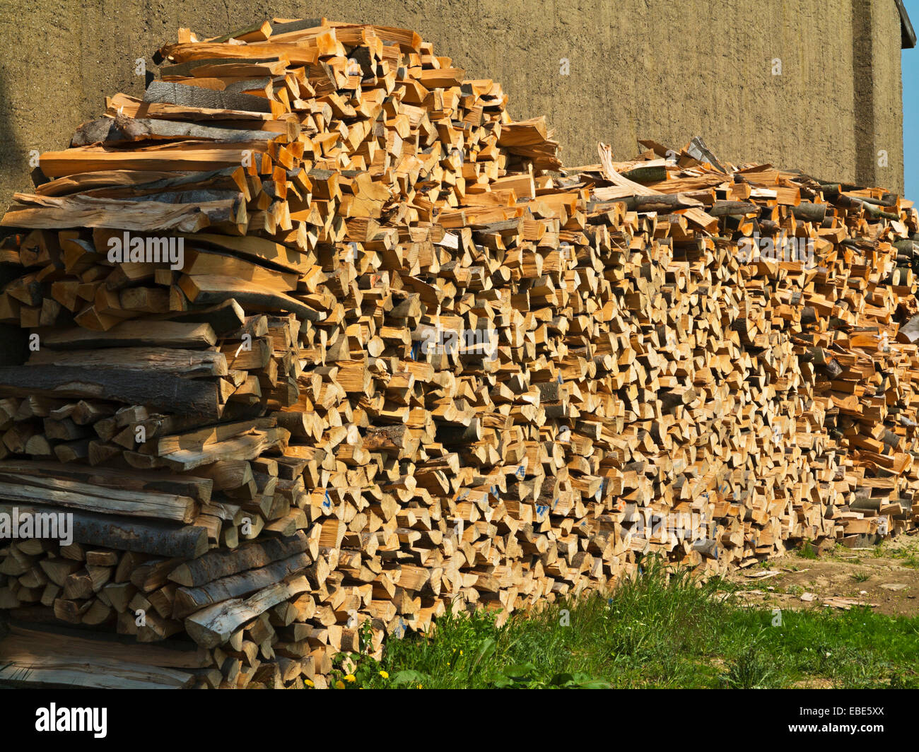 Stack of firewood next to building, Germany Stock Photo - Alamy