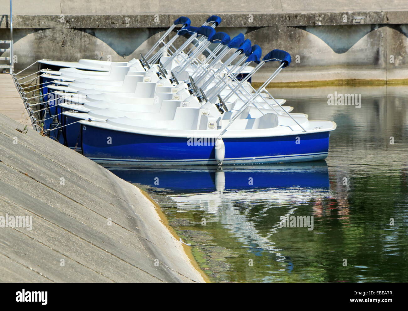 White and blue pedalos parked on the lakeside Stock Photo - Alamy