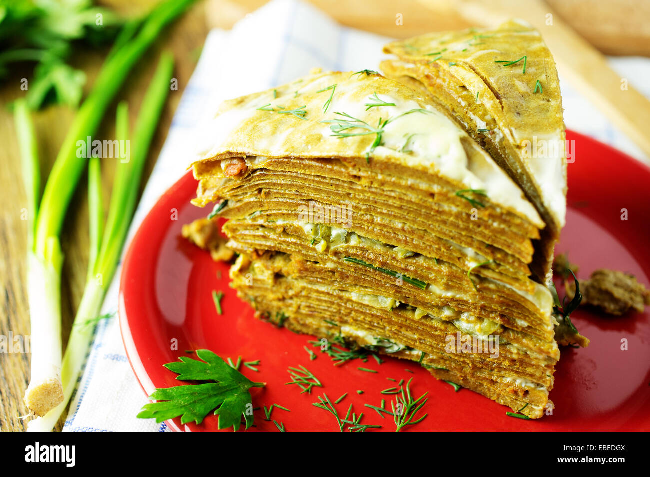 Liver pie two pieces on a plate with fresh herbs Stock Photo - Alamy
