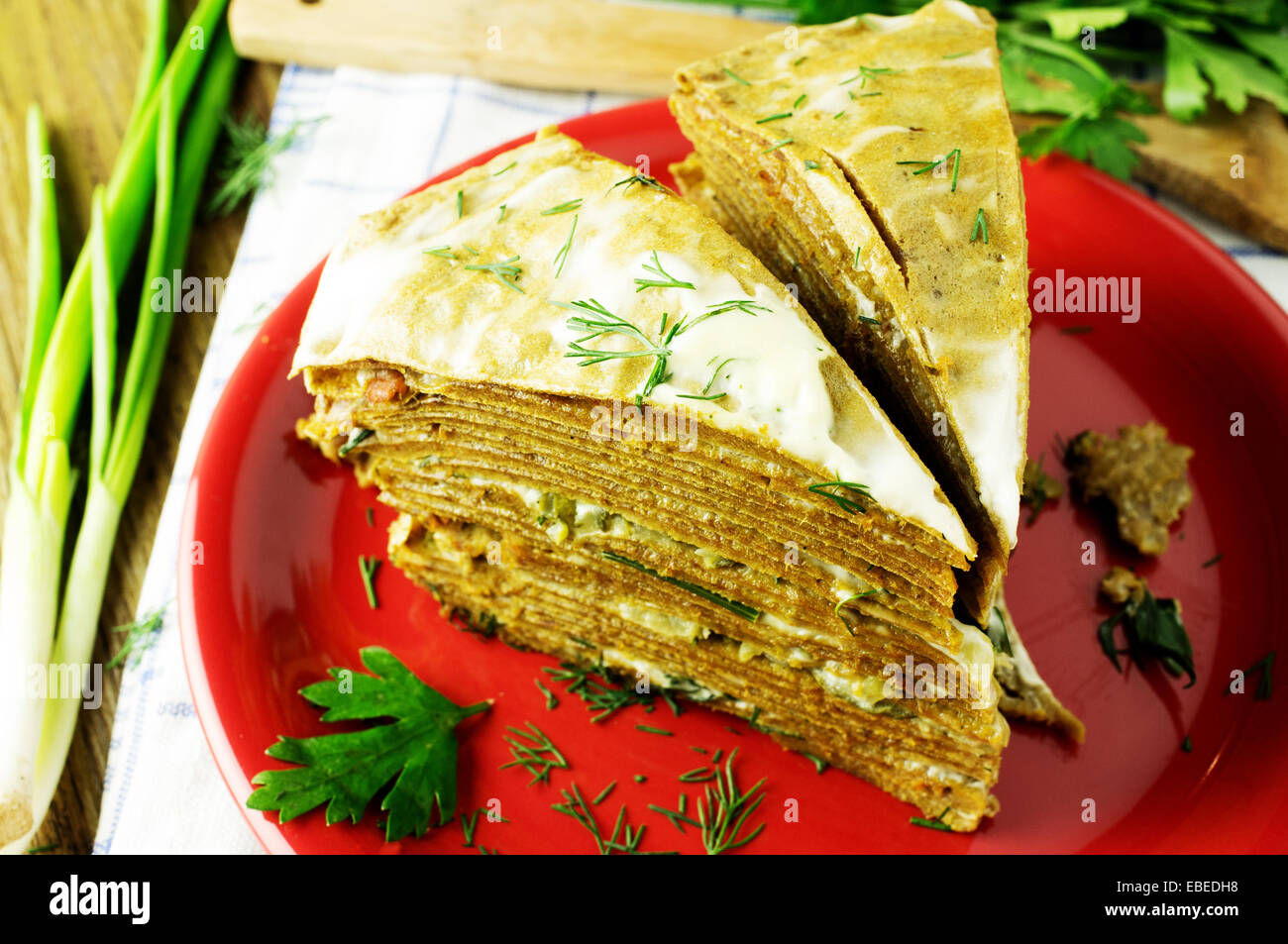 Liver pie two pieces on a plate with fresh herbs Stock Photo - Alamy