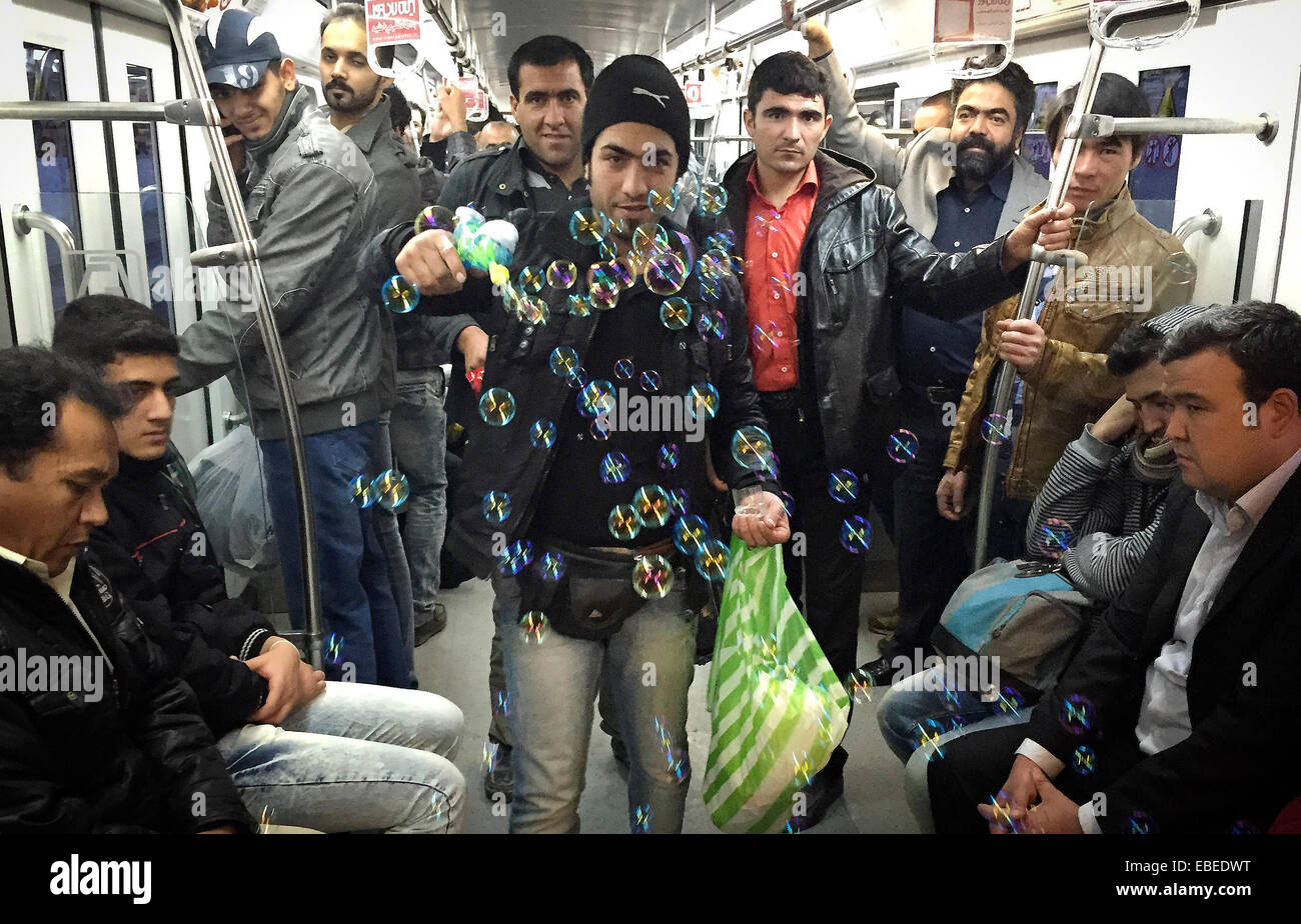 Tehran, Iran. 28th Nov, 2014. A vendor makes bubbles at subway Line 1 ...