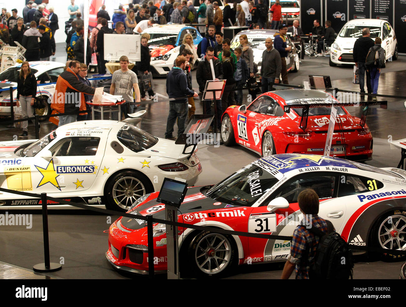 Visitors look at the exhibited cars at the 'Essen Motor Show' in Essen ...