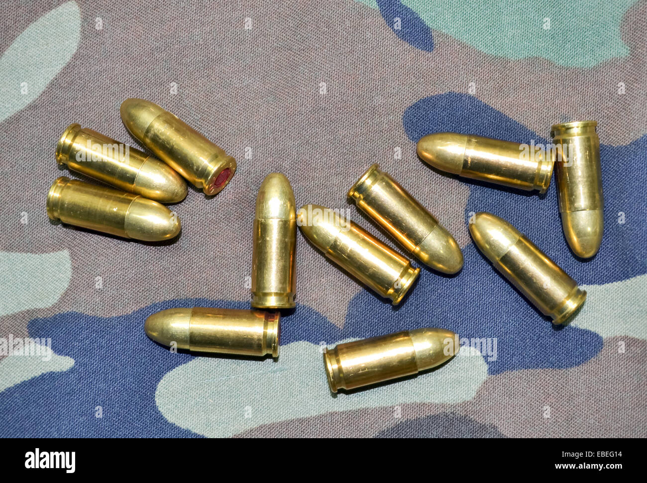 Eleven undischarged bullets on camouflage suit Stock Photo - Alamy