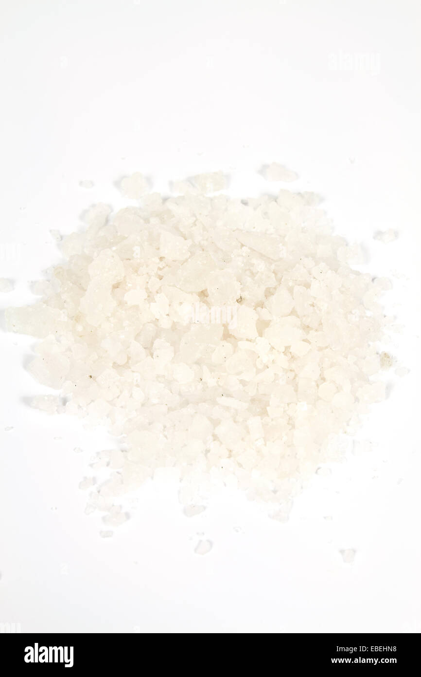 Pile of sea salt crystals on a white background Stock Photo - Alamy