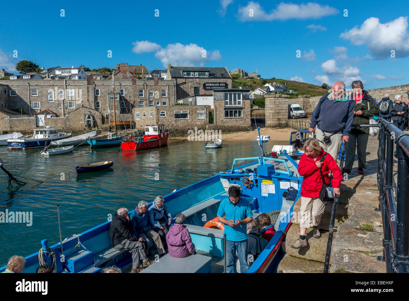 Tourists boarding a boat. Hugh Town harbour. St Mary's. Scilly Isles ...