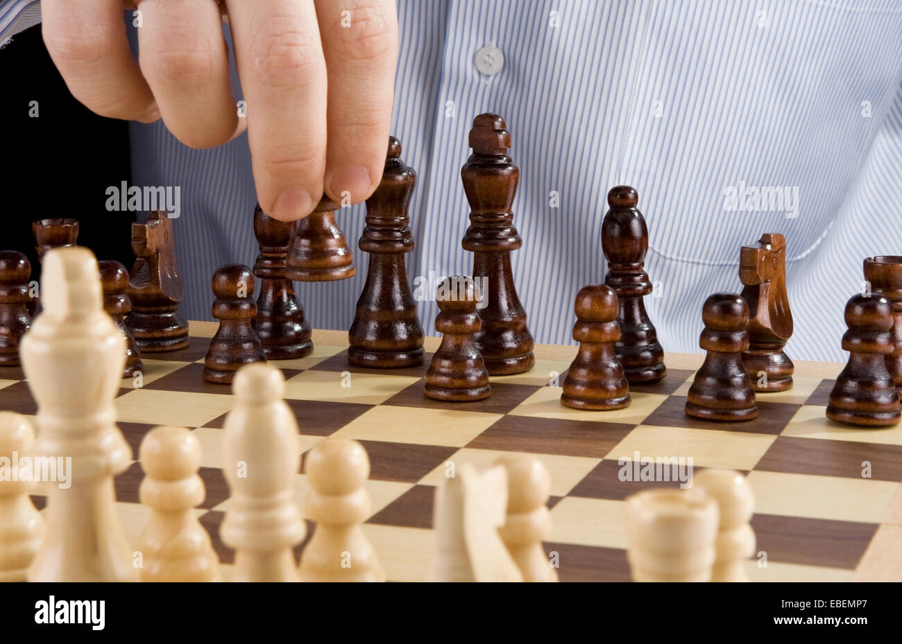 male hand moving chess black piece Stock Photo - Alamy