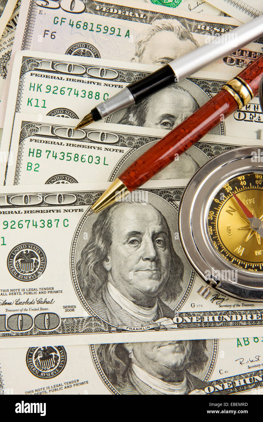 ink pens and gold compass on dollars Stock Photo - Alamy