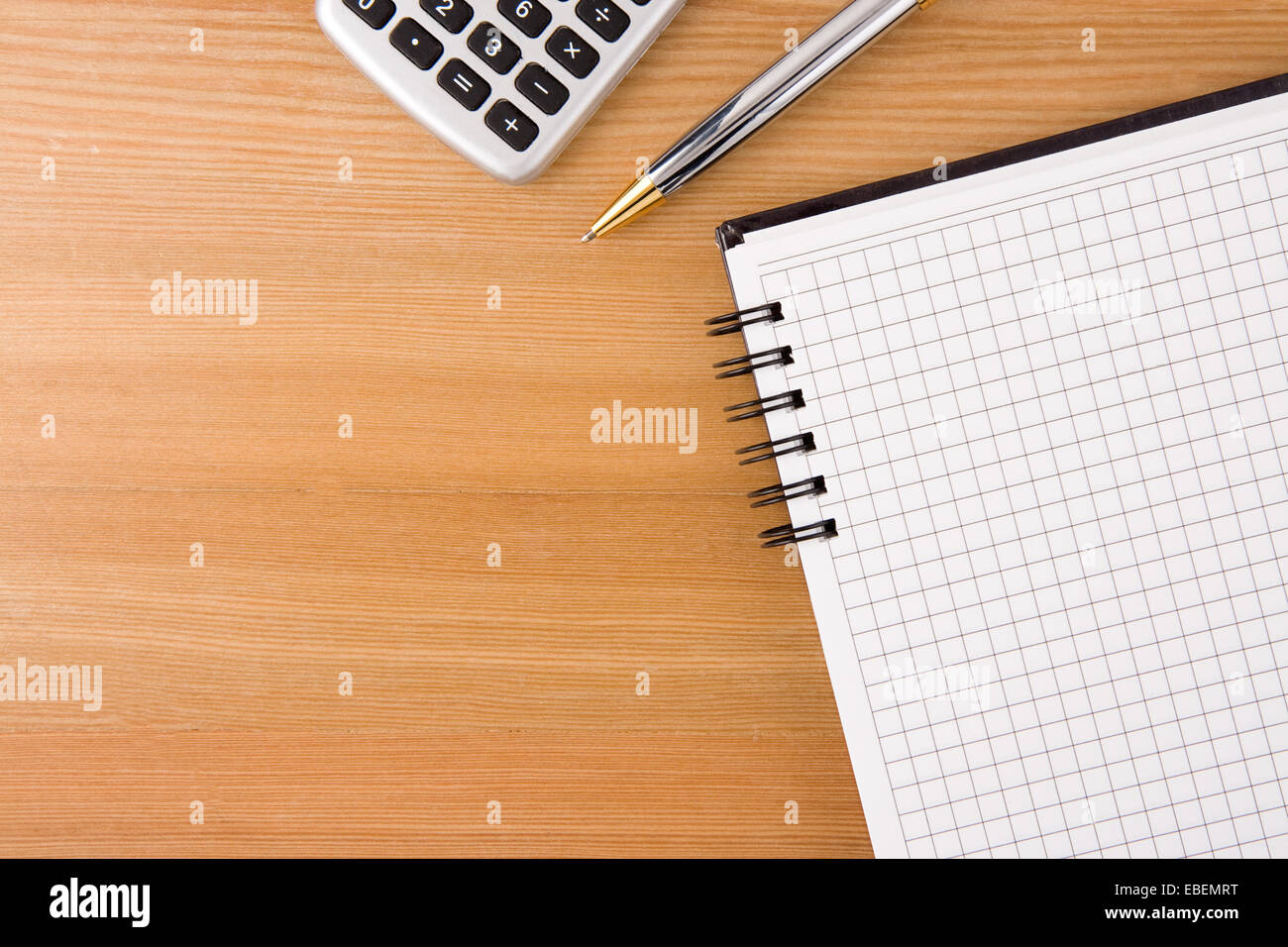 gold pen on checked notebook on wood Stock Photo - Alamy