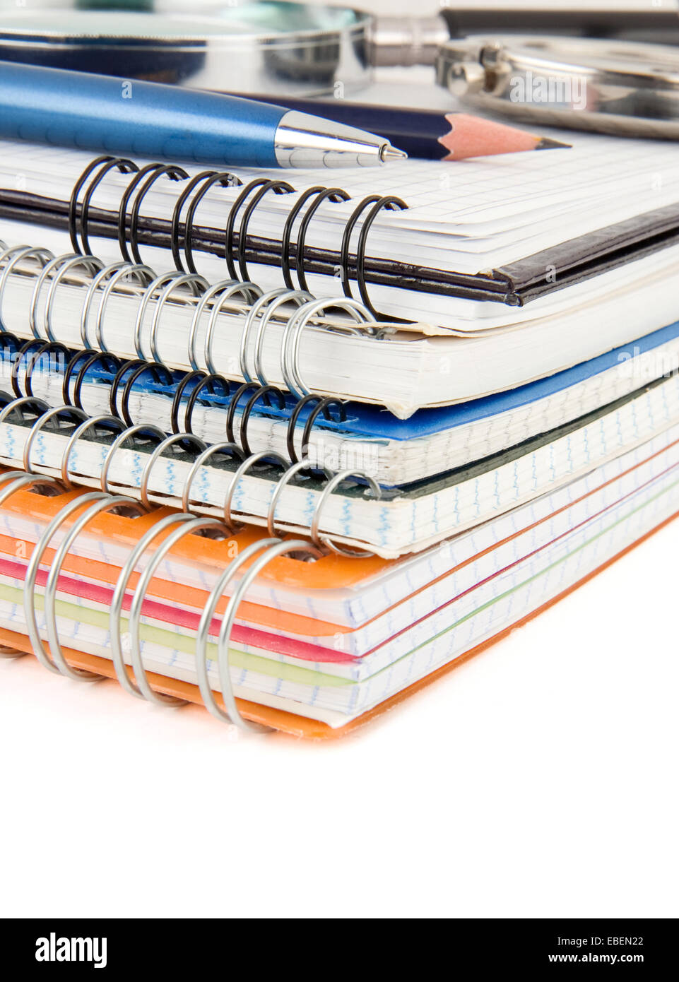 pen and pencil at notebook isolated on white background Stock Photo - Alamy