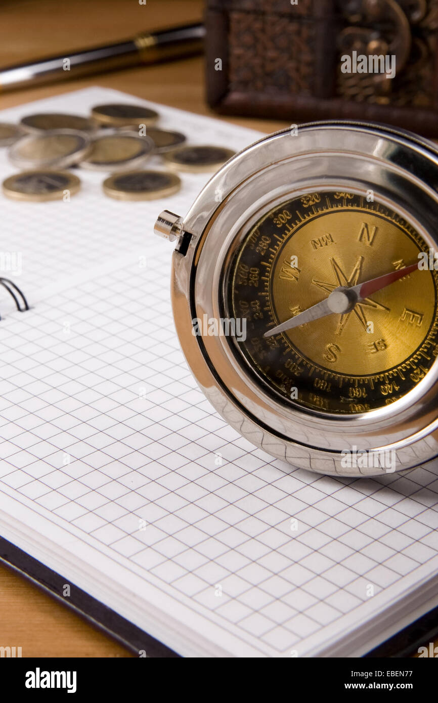 compass, pen and coin on checked notebook Stock Photo - Alamy