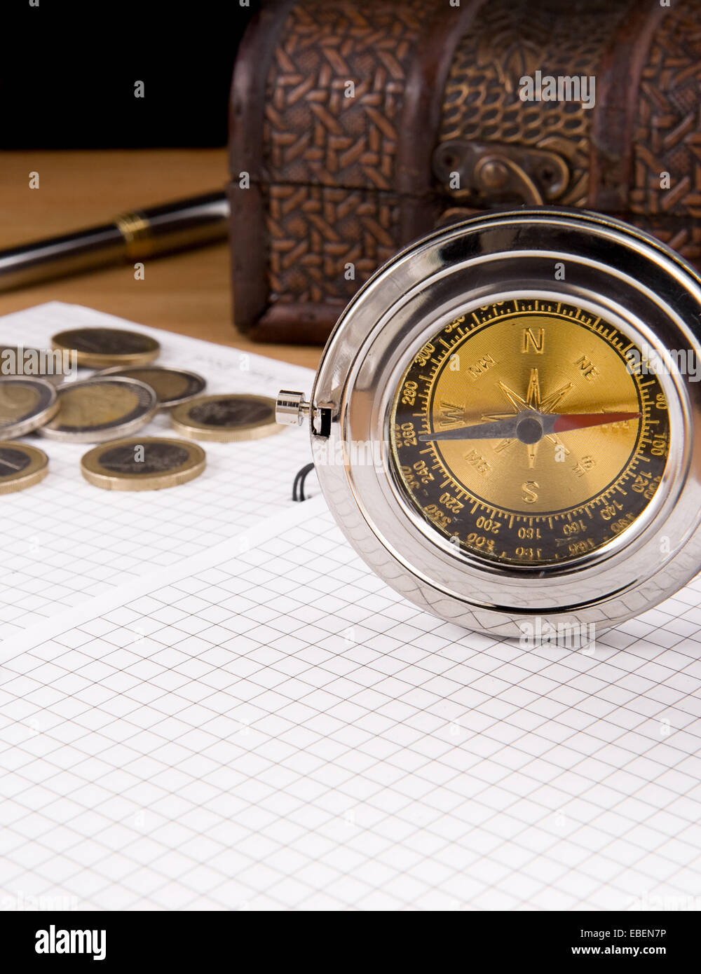 compass, pen and coin on checked notebook Stock Photo - Alamy