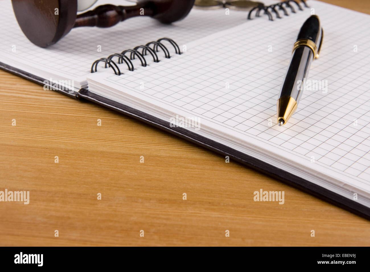 pen and coin on checked notebook Stock Photo - Alamy