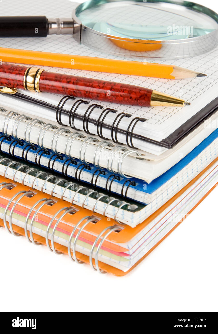 pen and pencil on checked notebook isolated on white background Stock ...