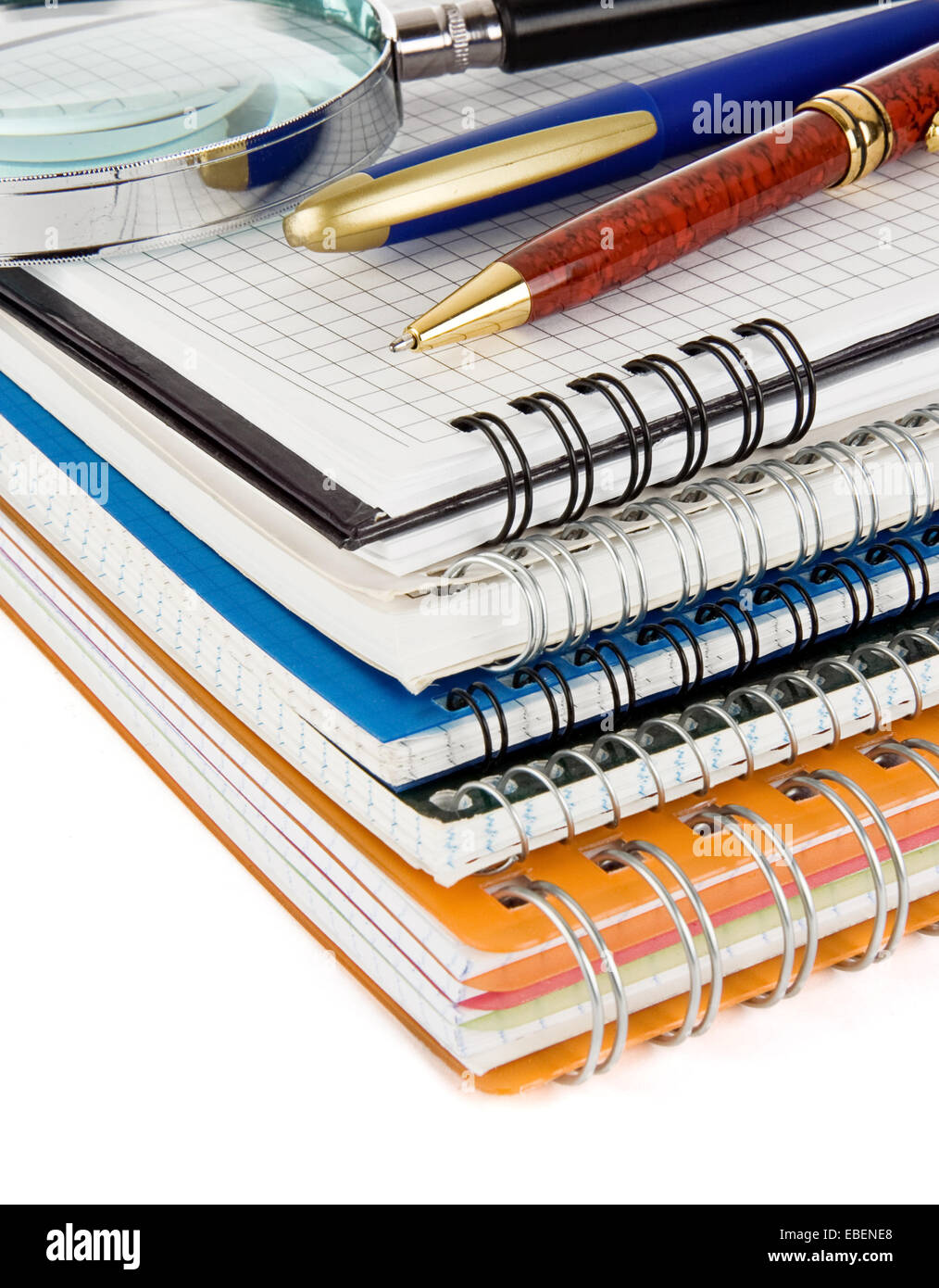 pen and pencil on checked notebook isolated on white background Stock ...