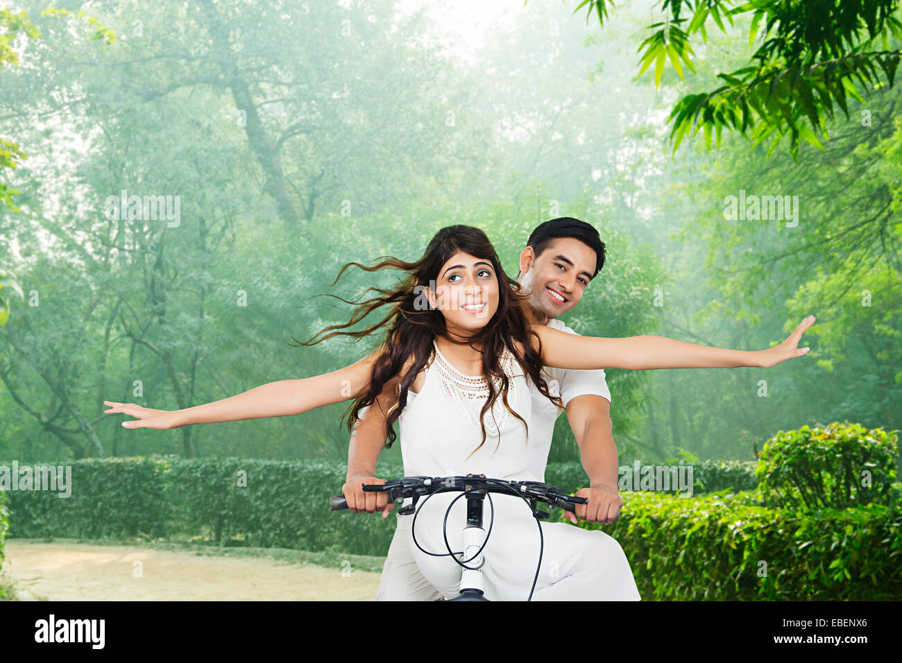 Playful lovers riding bicycle hi-res stock photography and images - Alamy