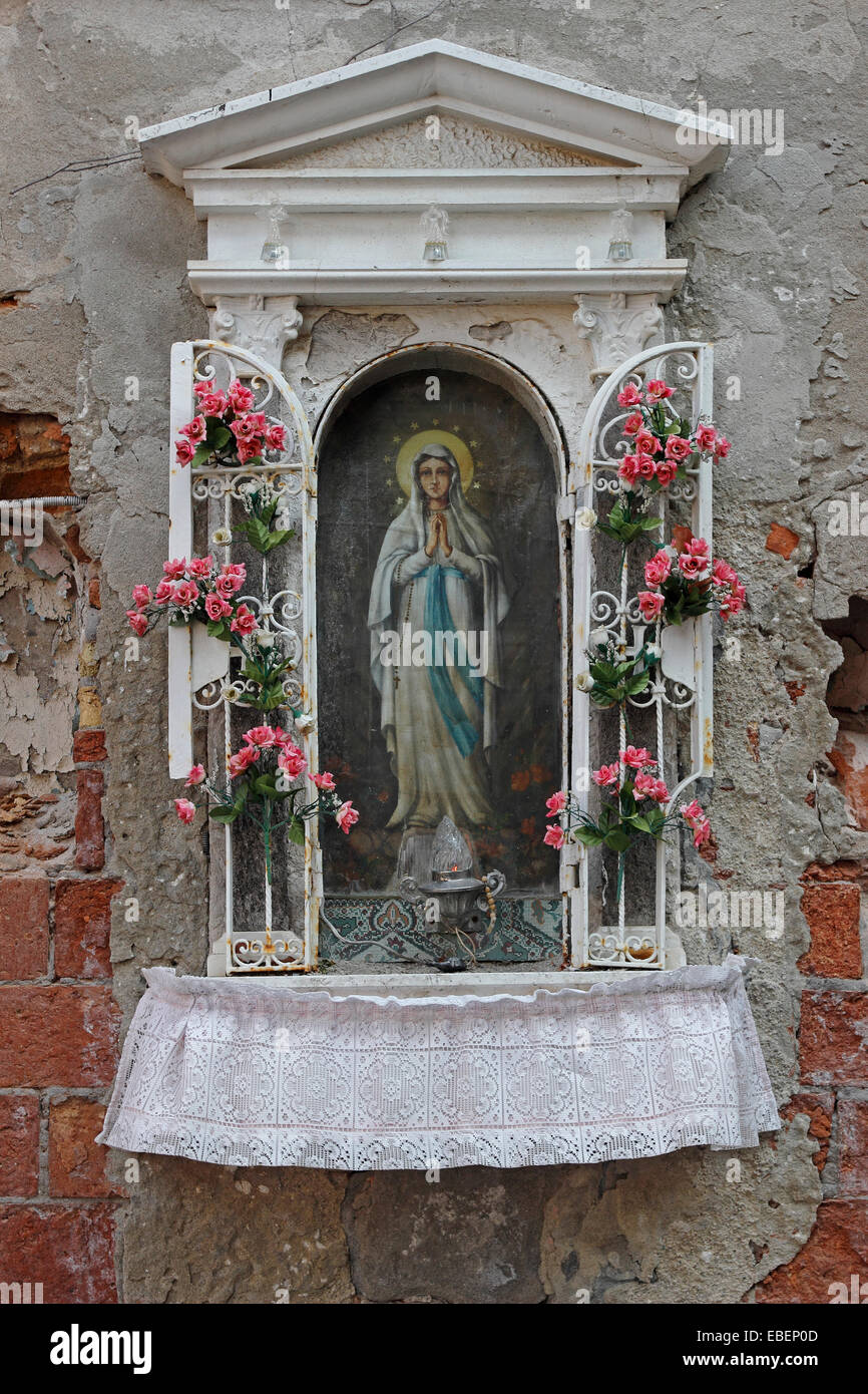 Venice Italy Castello religious icon Virgin Mary in stone wall Stock ...