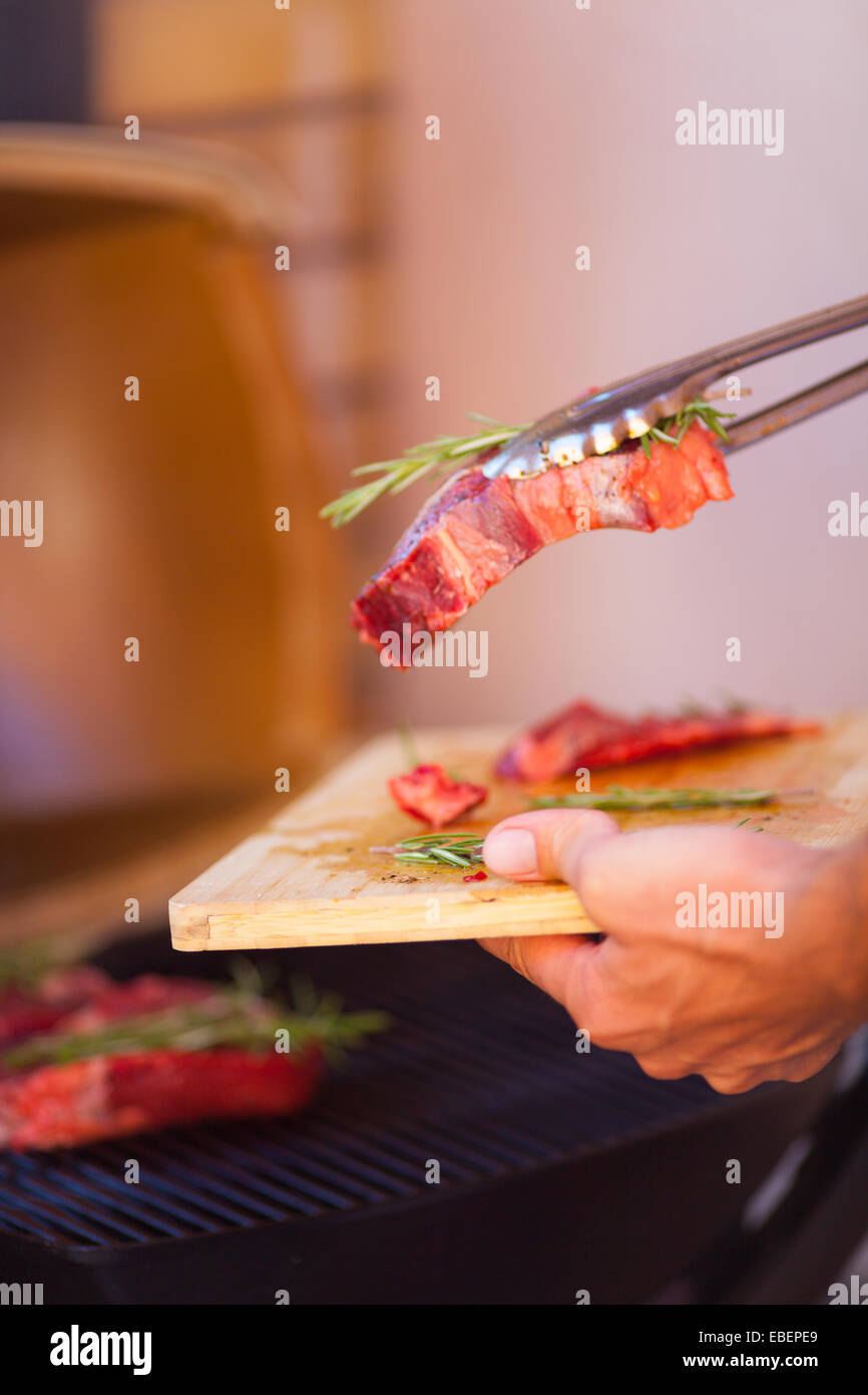 Human's hands closeup with steak fresh meat preparing on grill Stock ...