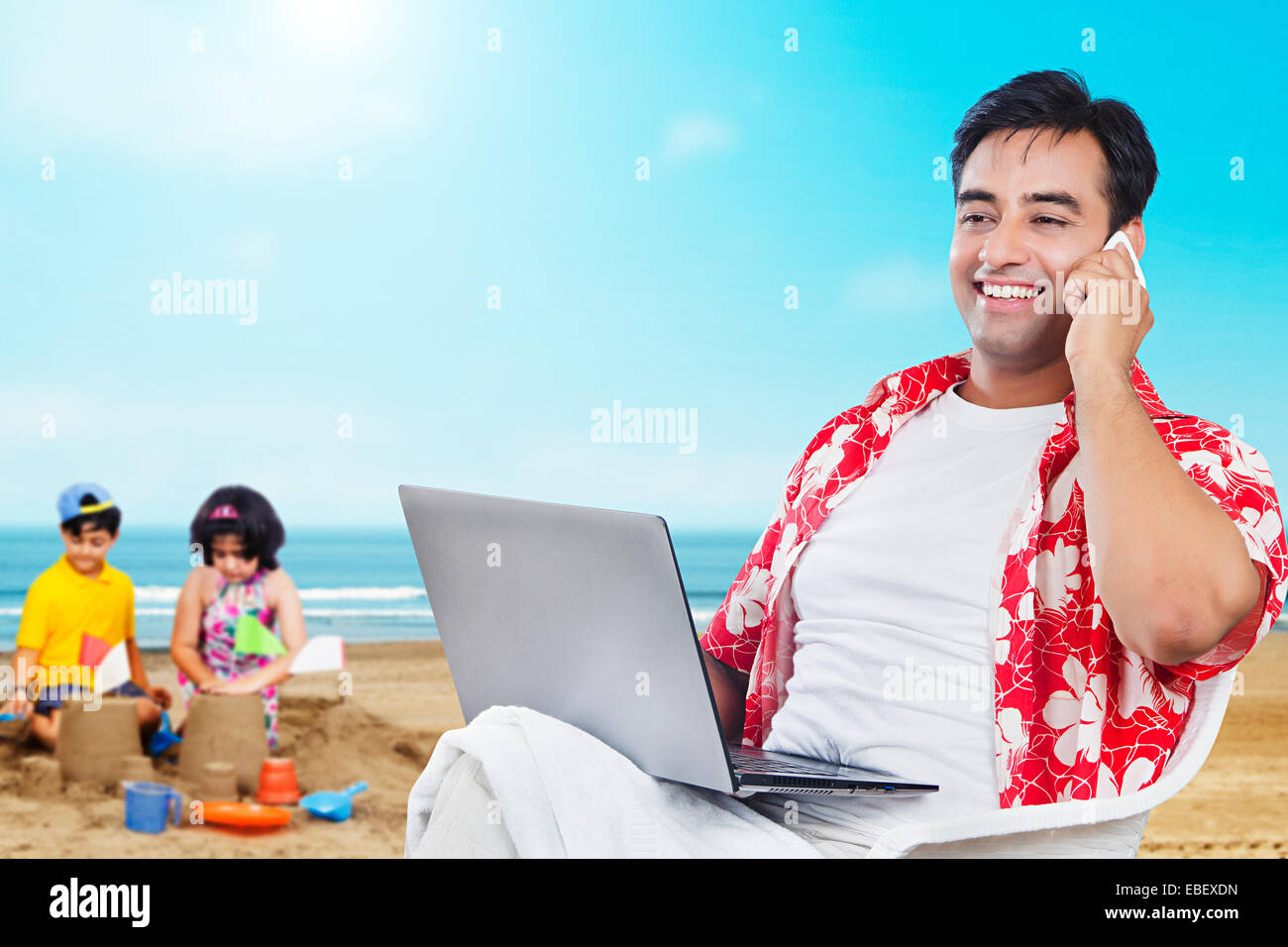 indian man beach Multi Tasking Stock Photo - Alamy