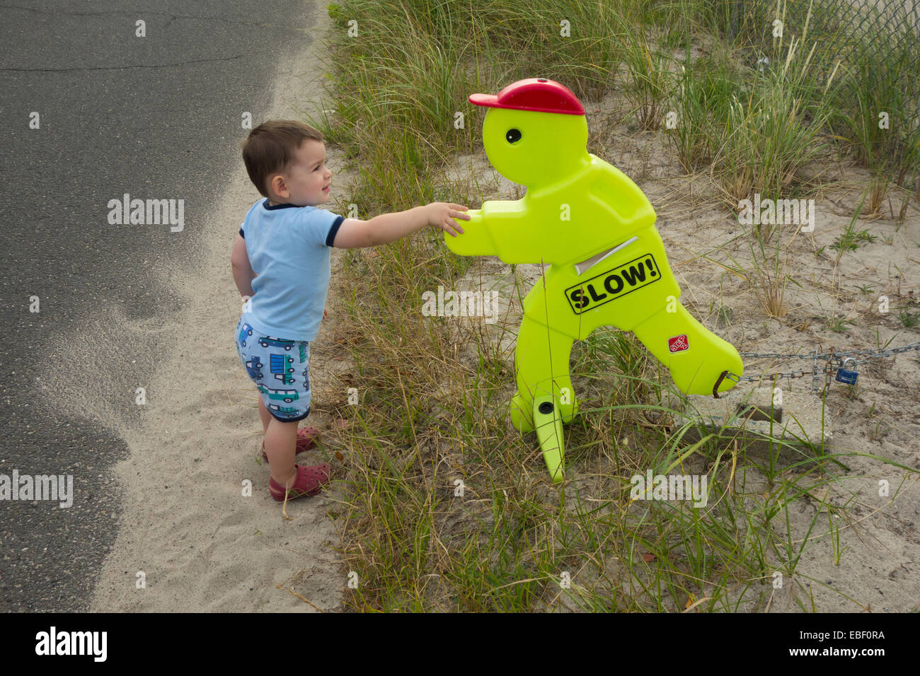 toddler boy holding hand of small plastic crossing guard Stock Photo ...