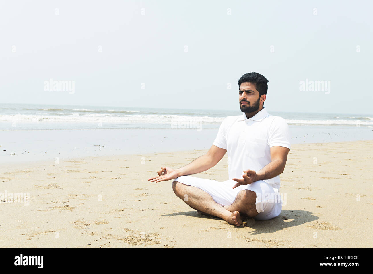 Indian man beach yoga hi-res stock photography and images - Alamy