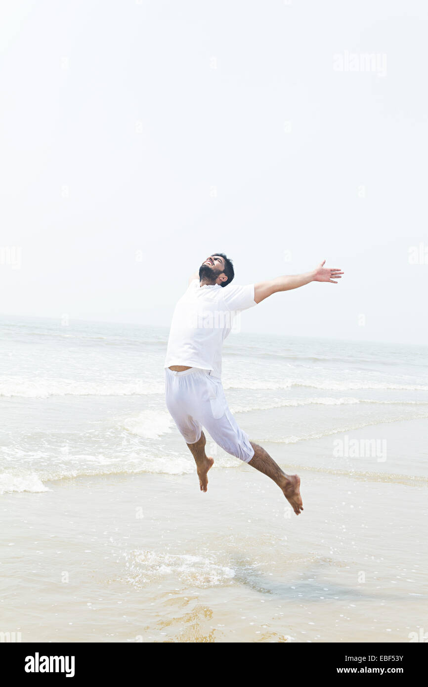 indian man beach jump Stock Photo - Alamy
