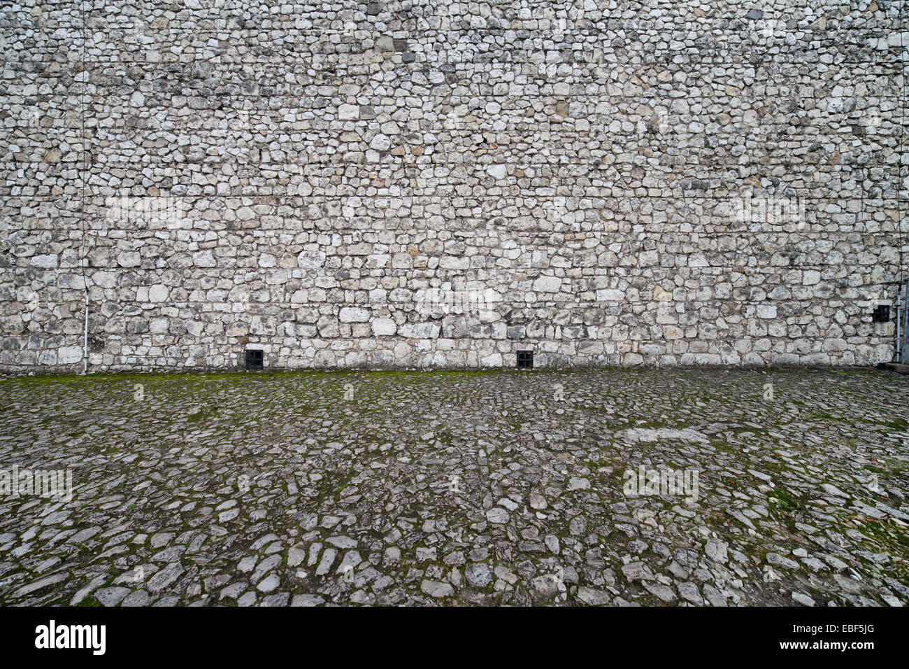 Medieval castle and cobbled square background, made of stone in 14th ...