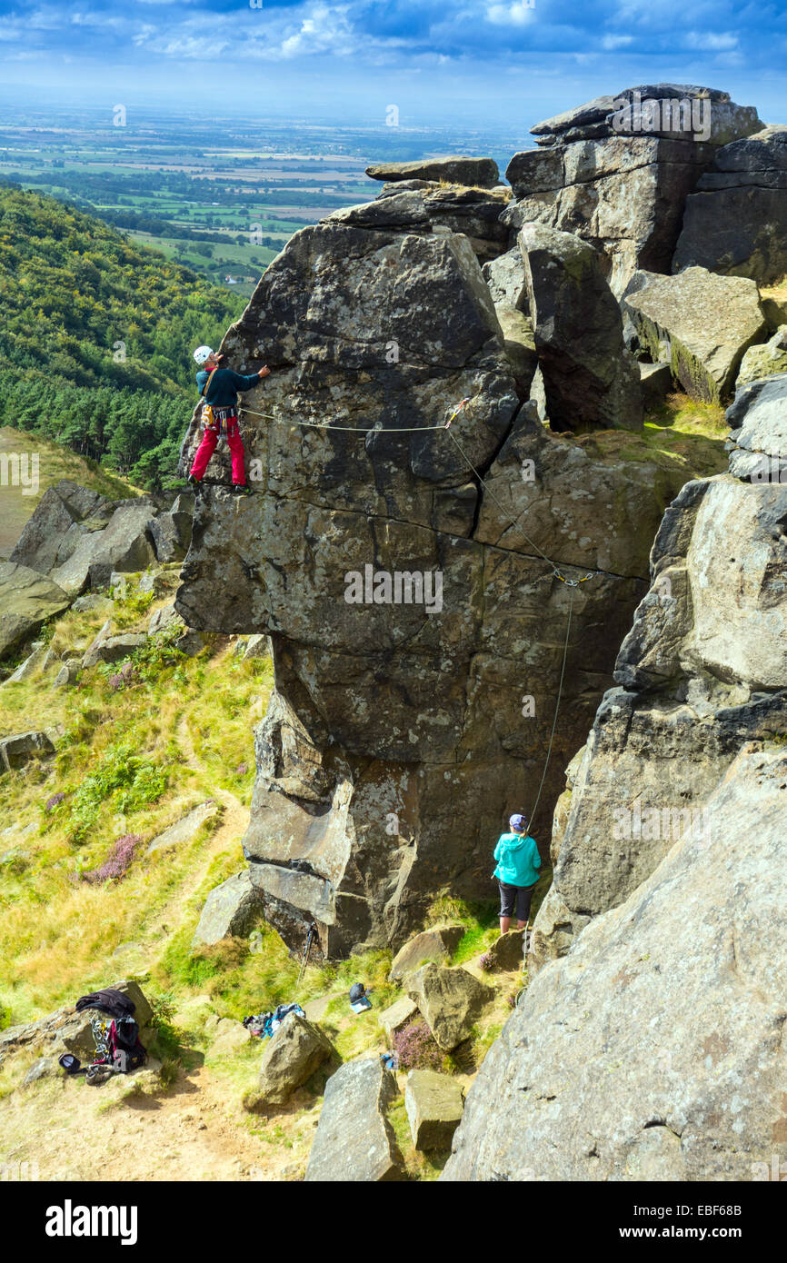 Rock climber at the Wainstones, a sandstone cliff on the North York ...