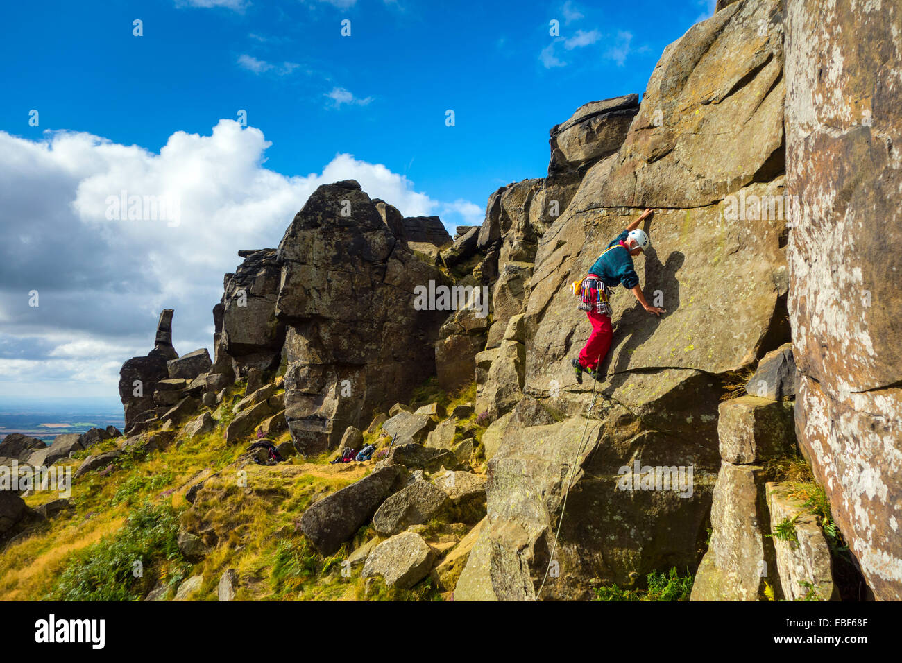 Rock climber at the Wainstones, a sandstone cliff on the North York ...