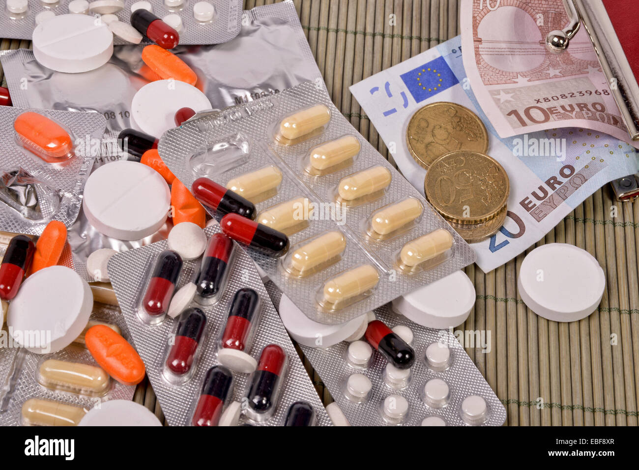 A pile of various drugs and pills with coins Stock Photo - Alamy