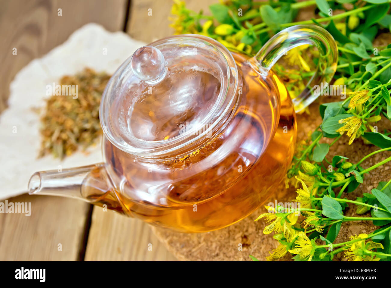 Tea with fresh and dry tutsan in glass teapo on board Stock Photo - Alamy