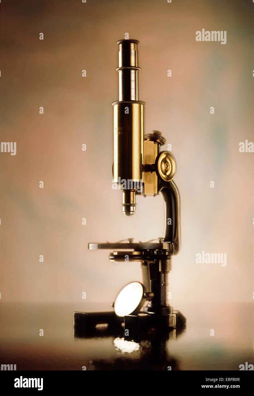 Classic microscope on brown background Stock Photo - Alamy