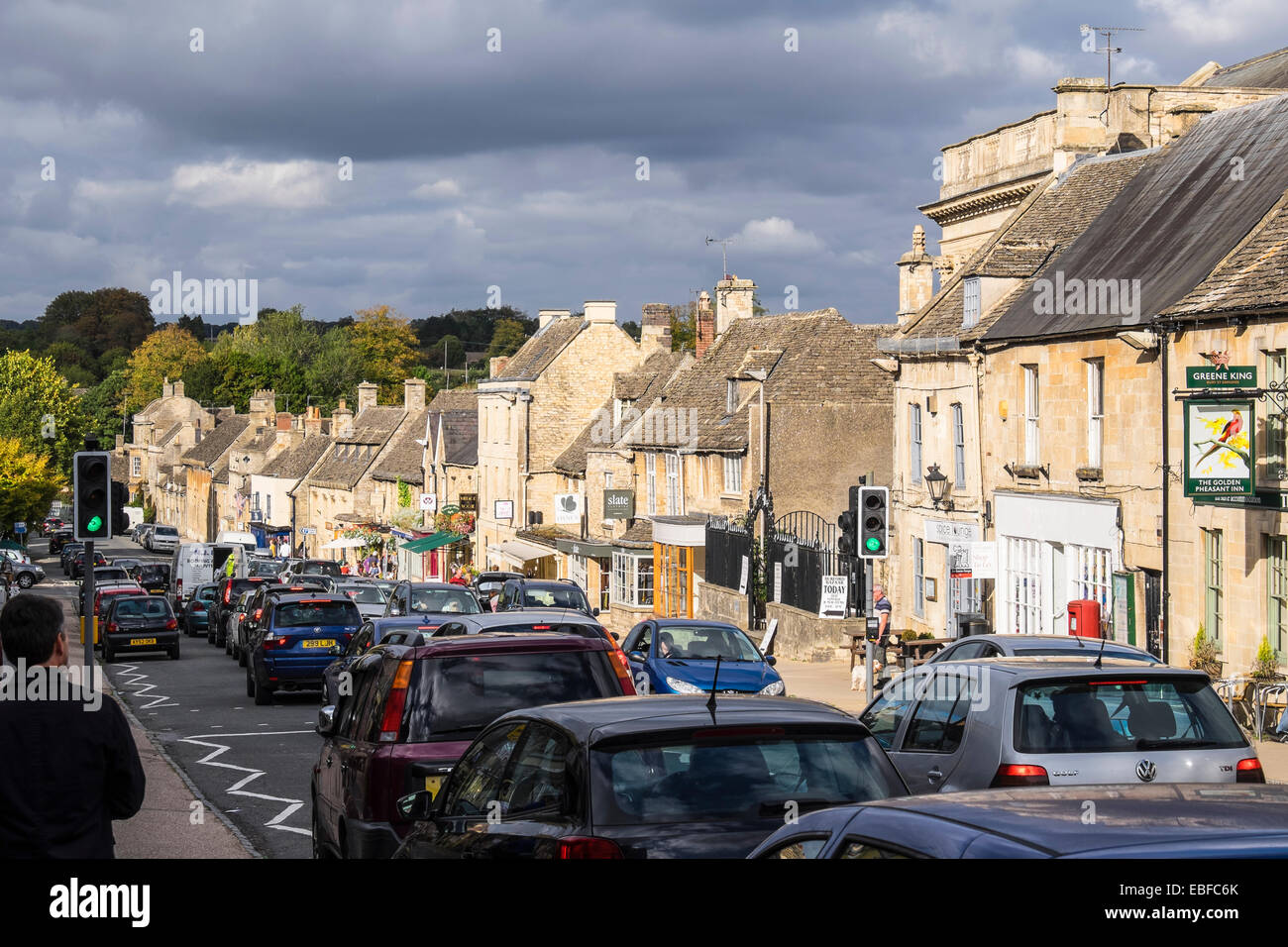 View down the High Street Burford Oxfordshire England with sun shining ...