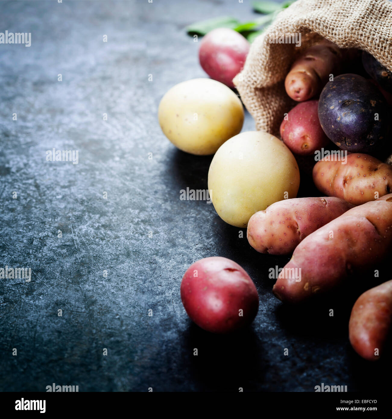 Raw colorful potatoes in burlap bag Stock Photo - Alamy
