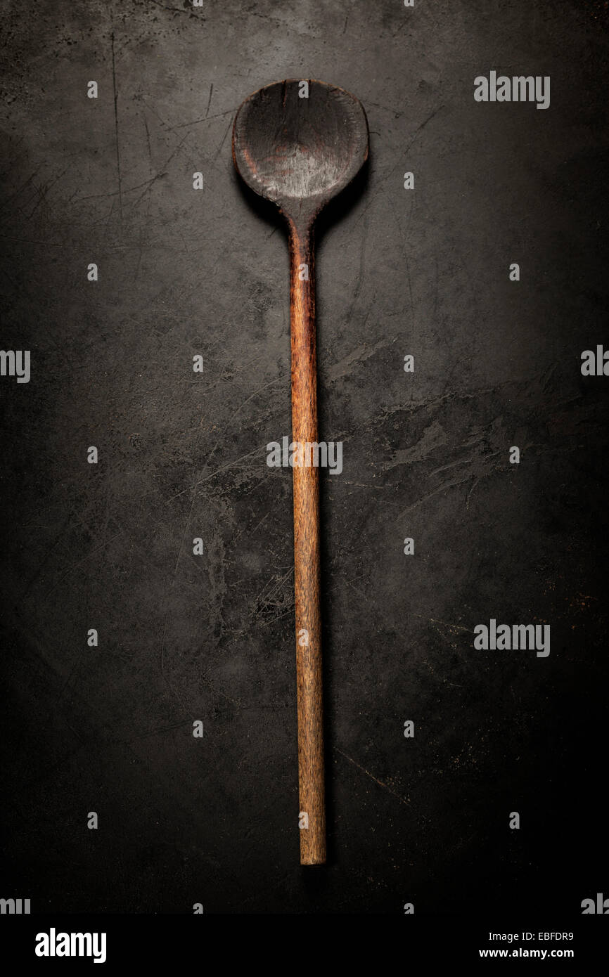 old wooden spoon on dark background Stock Photo - Alamy