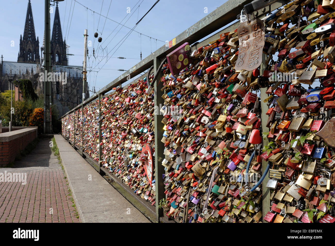 Love locks on the railing of the Hohenzollern Bridge near cathedral and ...