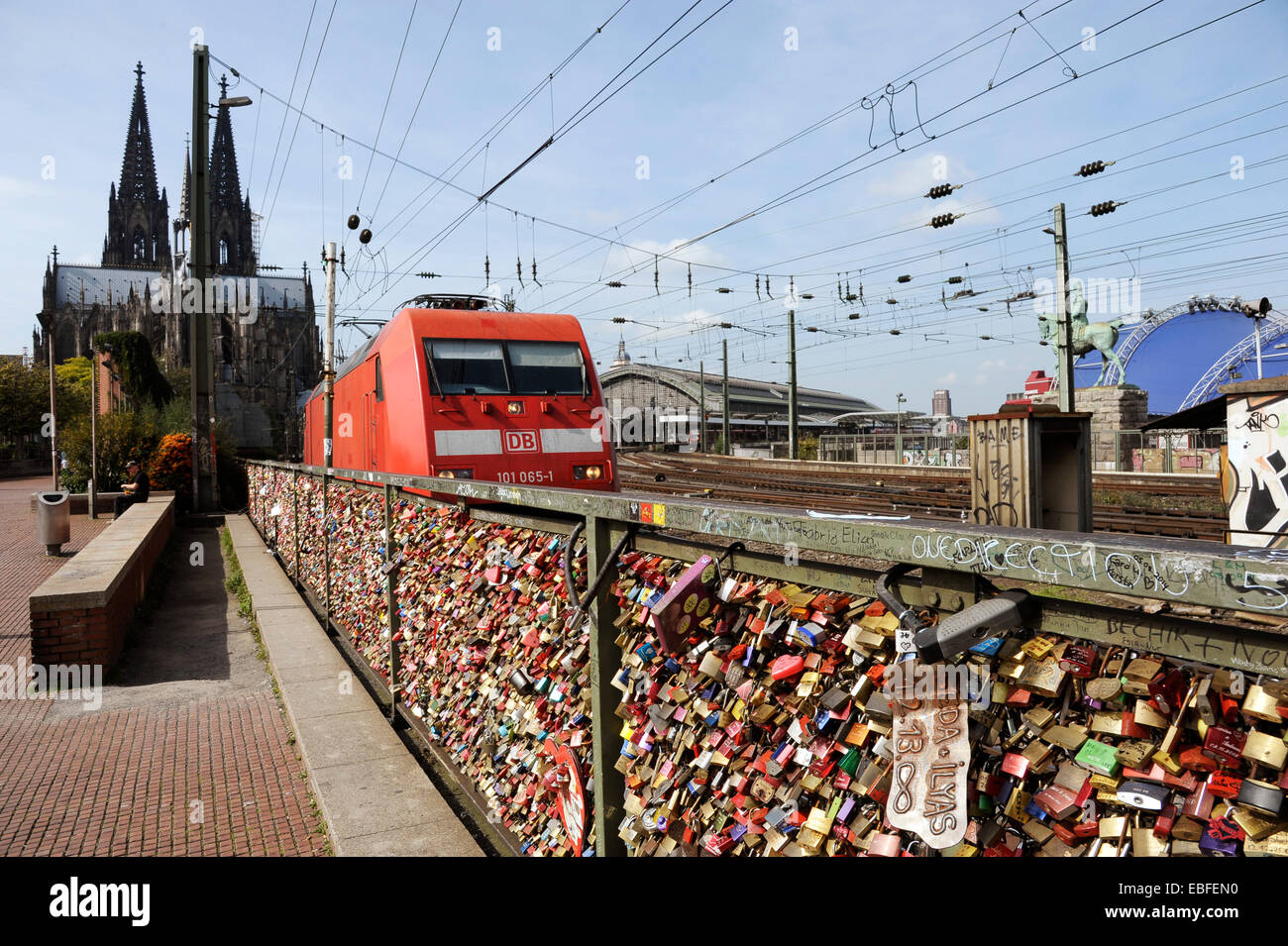 Love locks on the railing of the Hohenzollern Bridge near cathedral and ...
