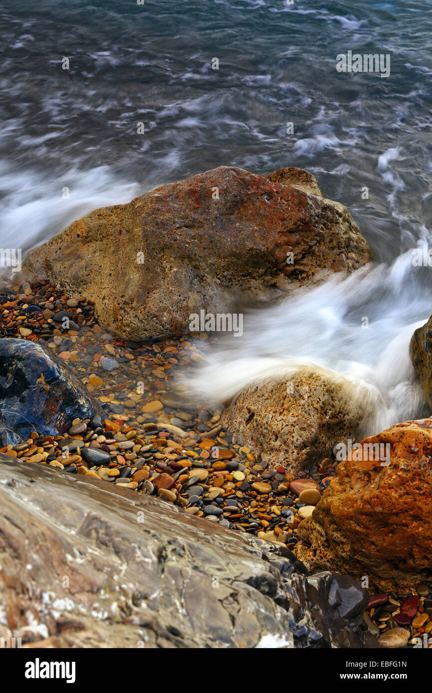 Swirling sea on rocky groyne Stock Photo - Alamy