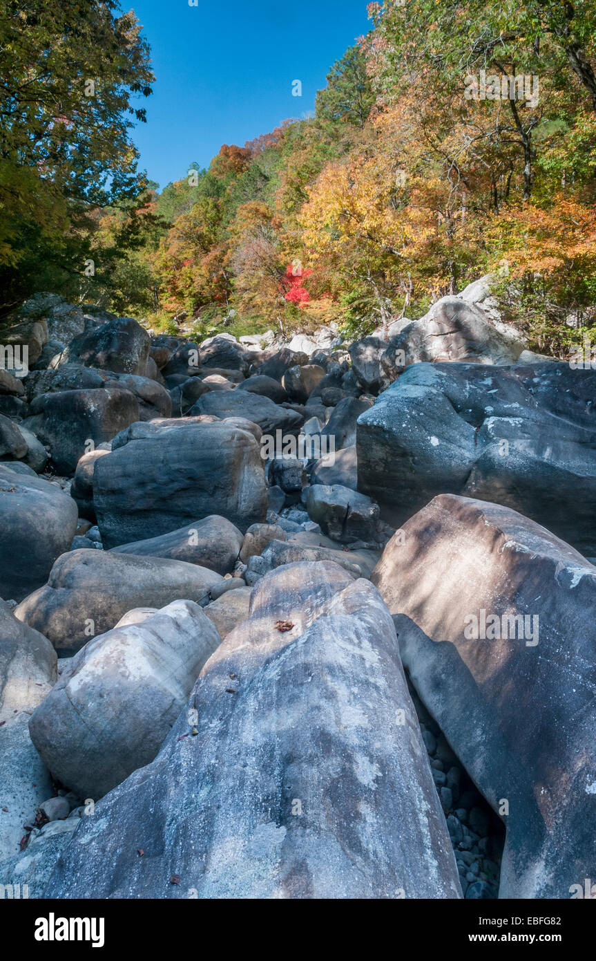 An autumn view of changing colors looking along the exposed rock of a ...