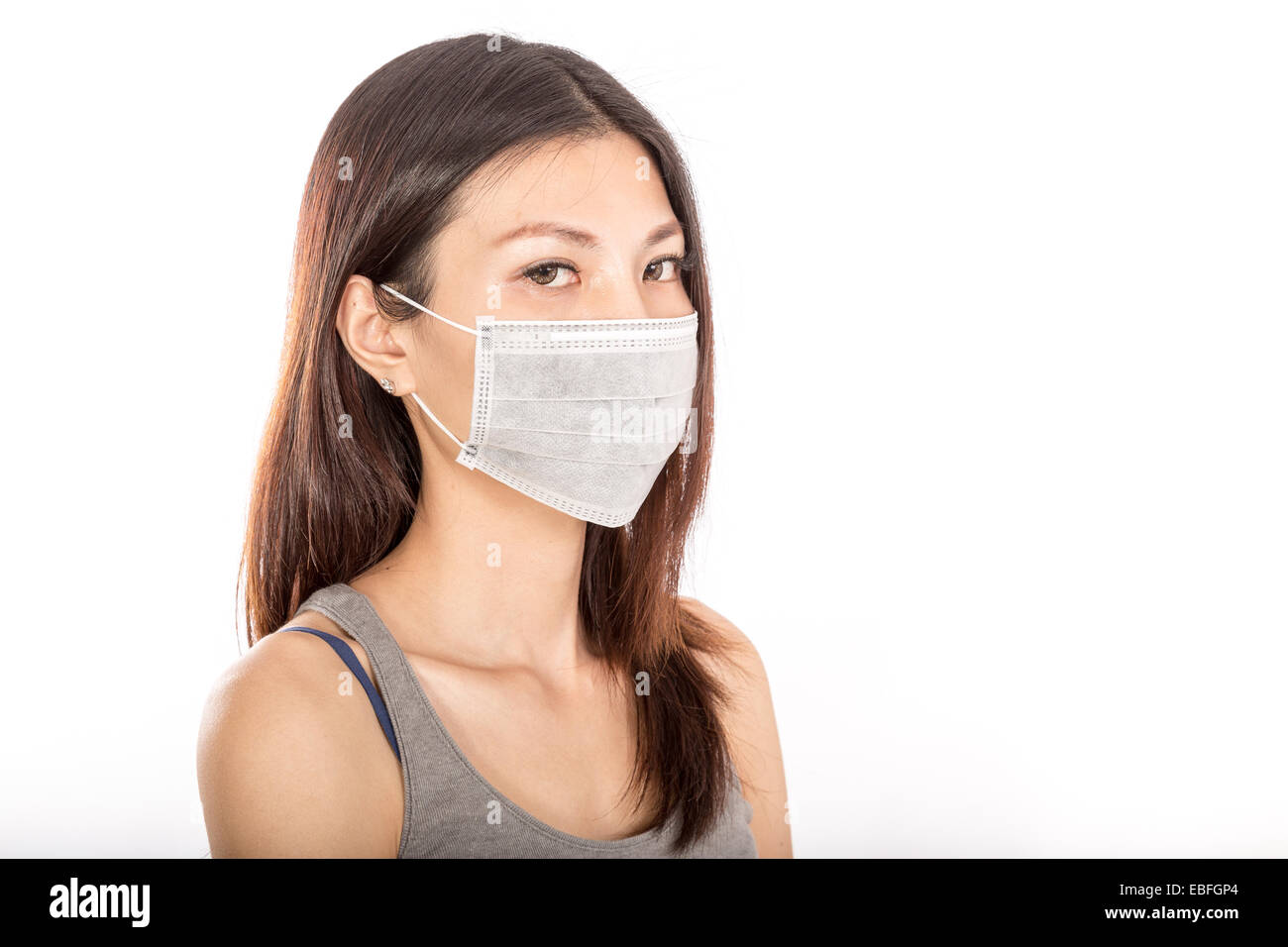 Chinese woman wearing surgical mask with white background Stock Photo ...