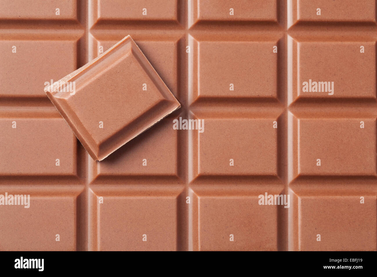 Slice of milk chocolate put on a chocolate block Stock Photo - Alamy